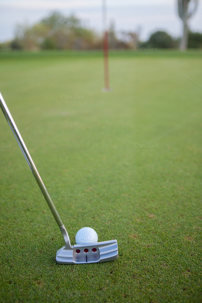 Golf Ball on Green with Putter ~ Photos on Creative Market